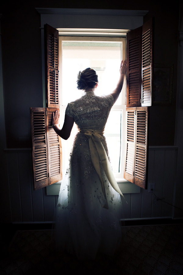 the beautiful bride standing in window light - photo by Southern ...