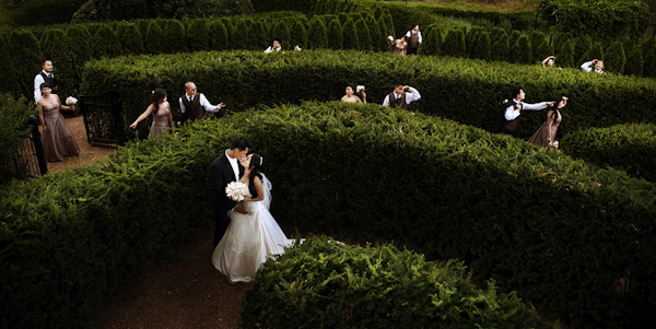 bridal party looking for couple in a maze - wedding photo by Kenny ...