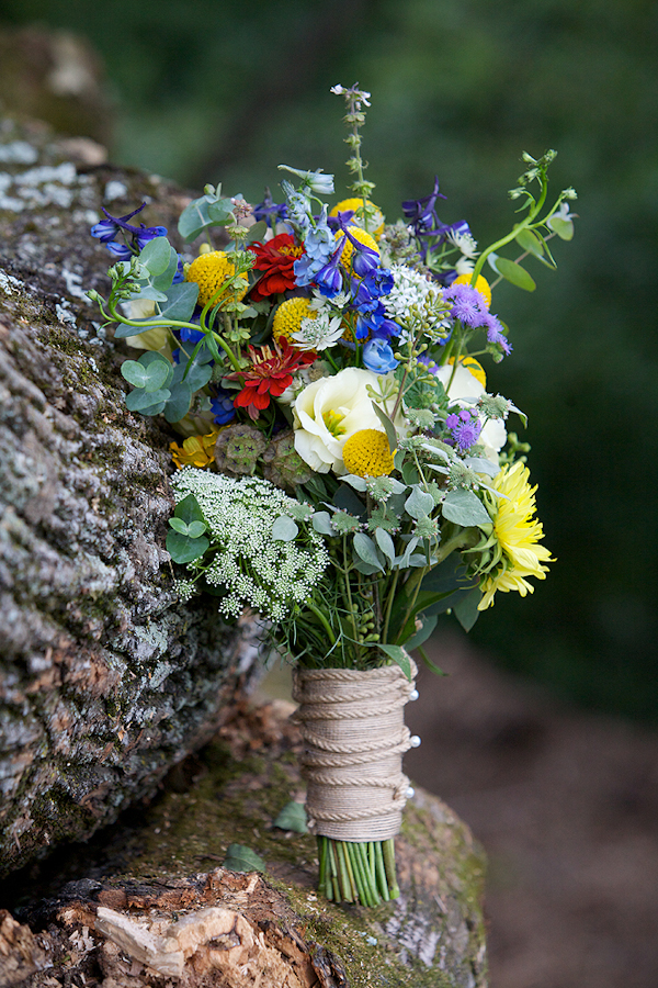 white, yellow, blue and red bouquet on rocks - wedding photo by top ...